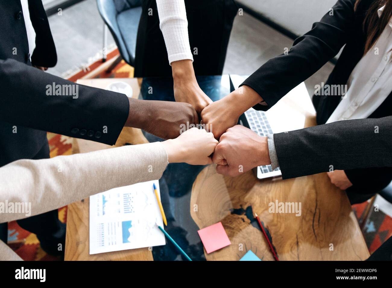 Great teamwork. Top view of hands of a successful multiracial business ...