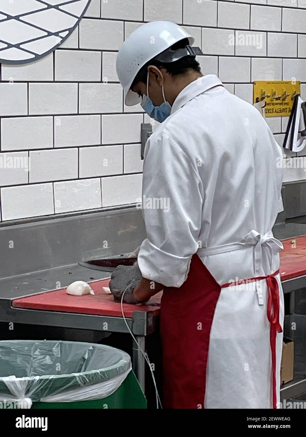 FRESNO, UNITED STATES - Feb 22, 2021: A profile of a Butcher cutting ...