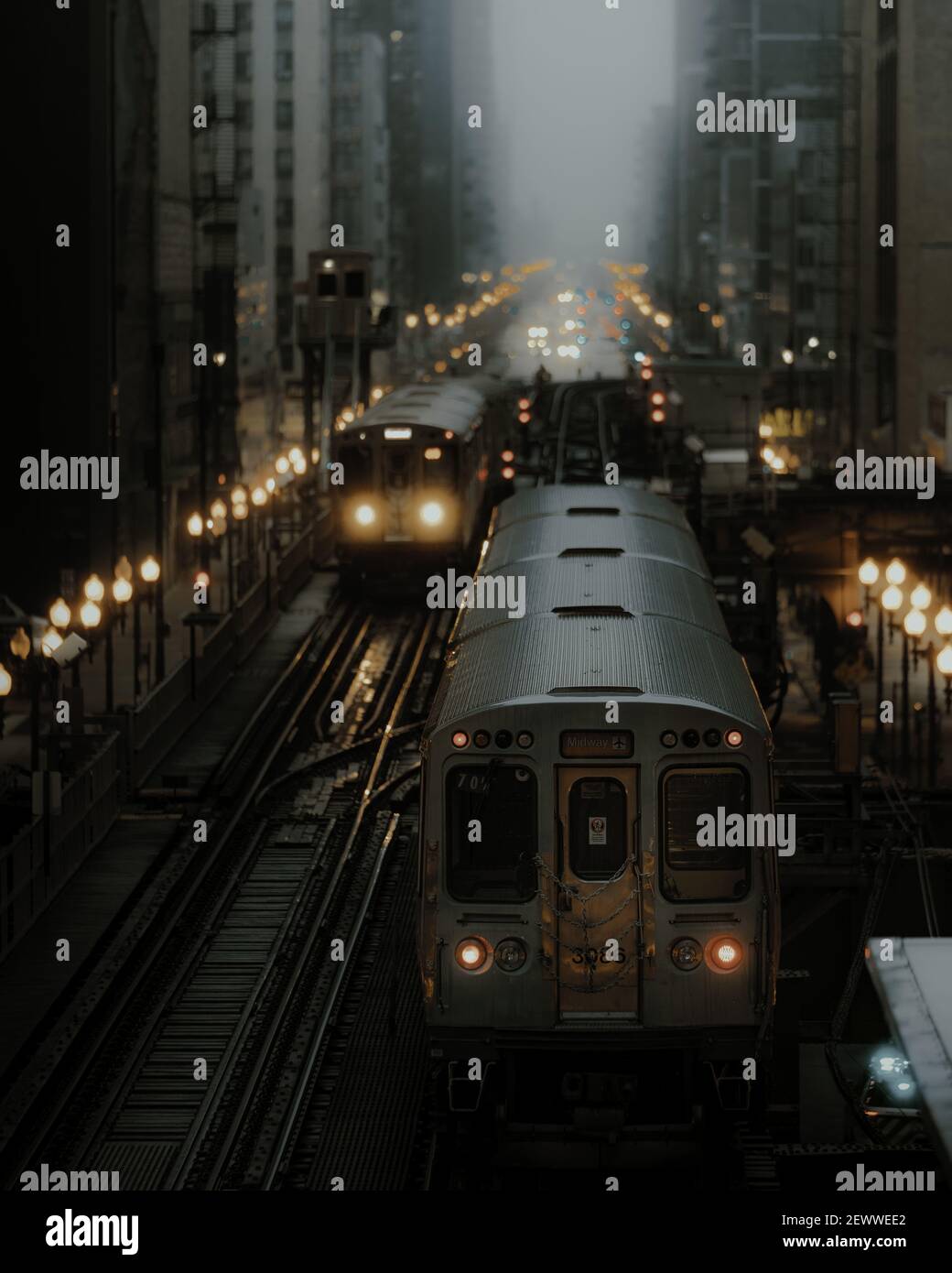 A beautiful shot of two speeding trains moving in opposite directions on a foggy day in autumn ...