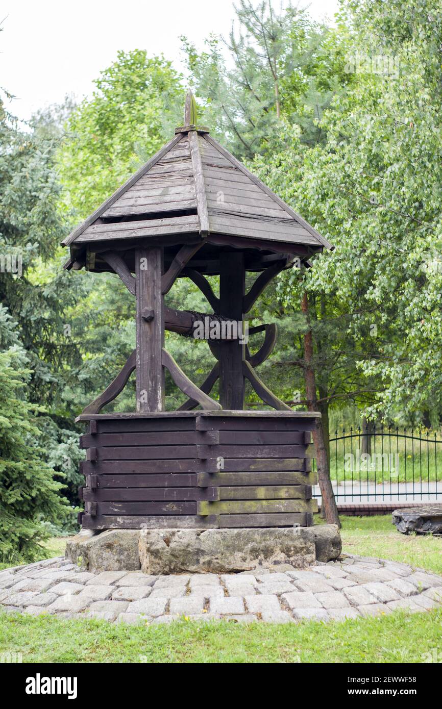 An old and historic wooden well standing in the garden, surrounded by ...