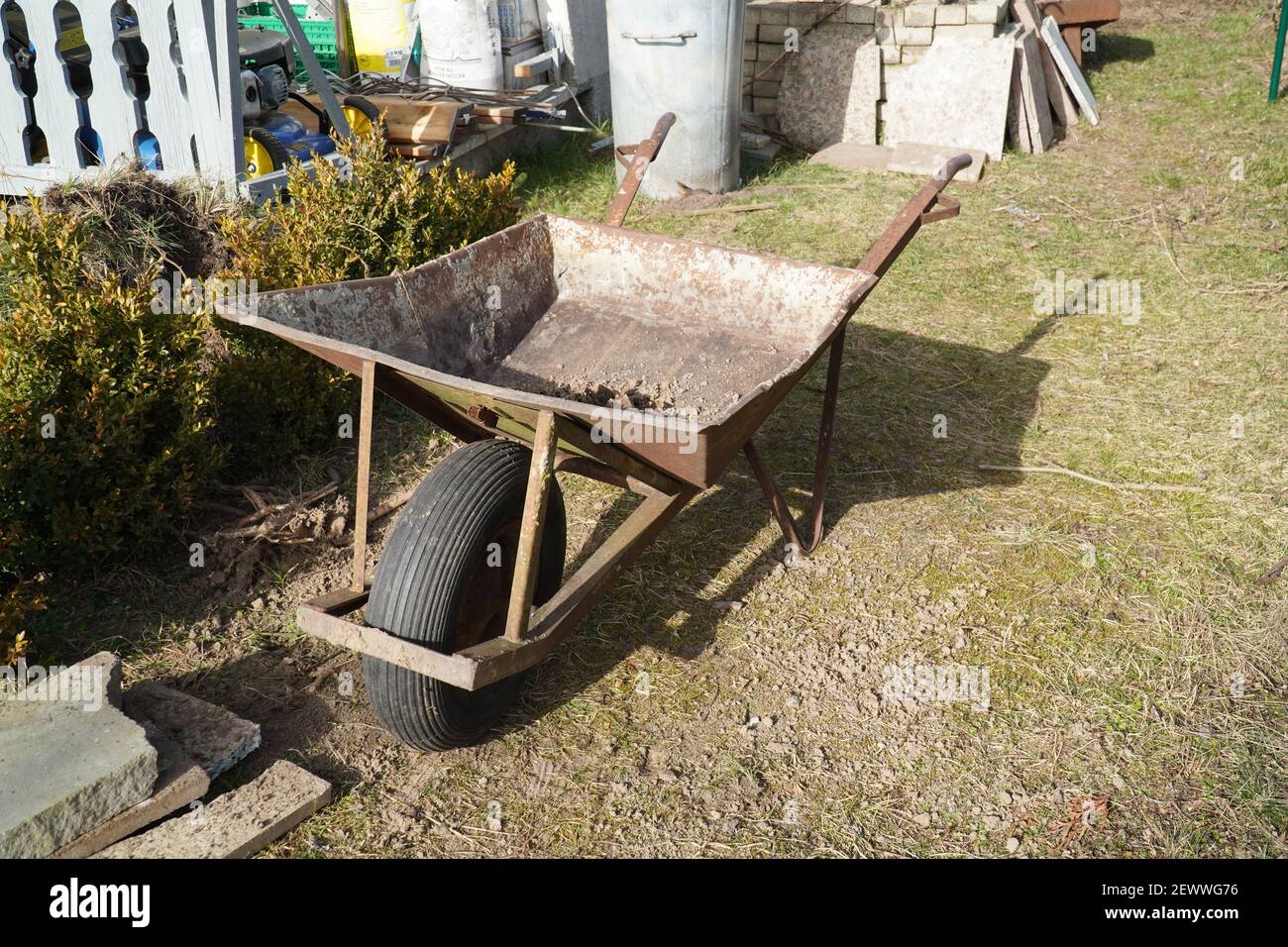 An old rusty wheelbarrow in the garden Stock Photo - Alamy