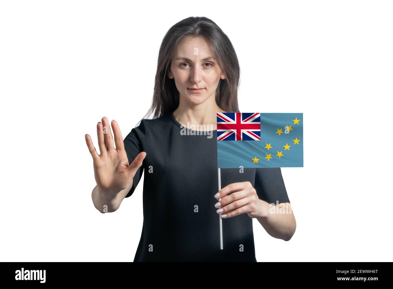 Happy young white woman holding flag of Tuvalu and with a serious face ...