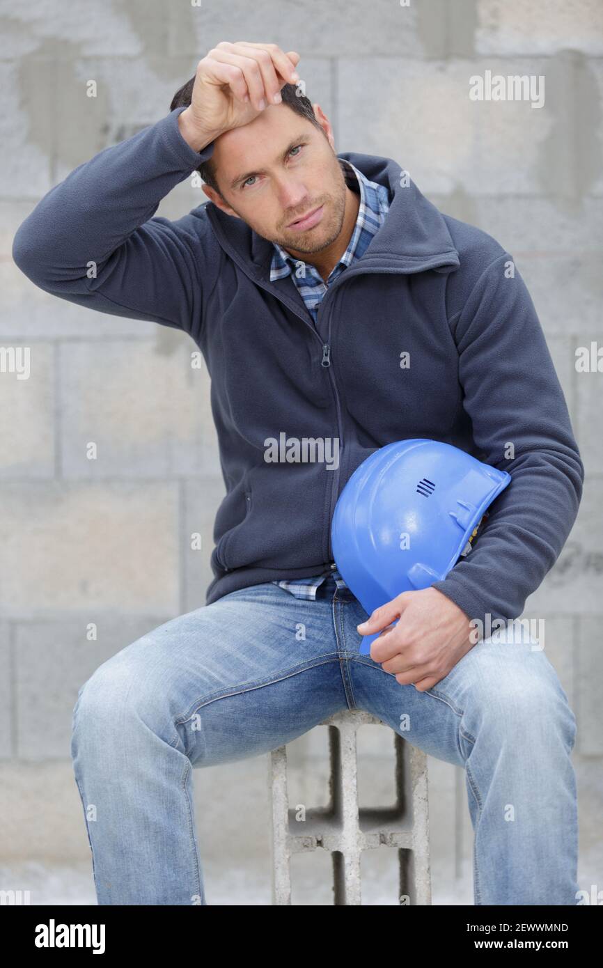 workman with helmet with tired Stock Photo - Alamy