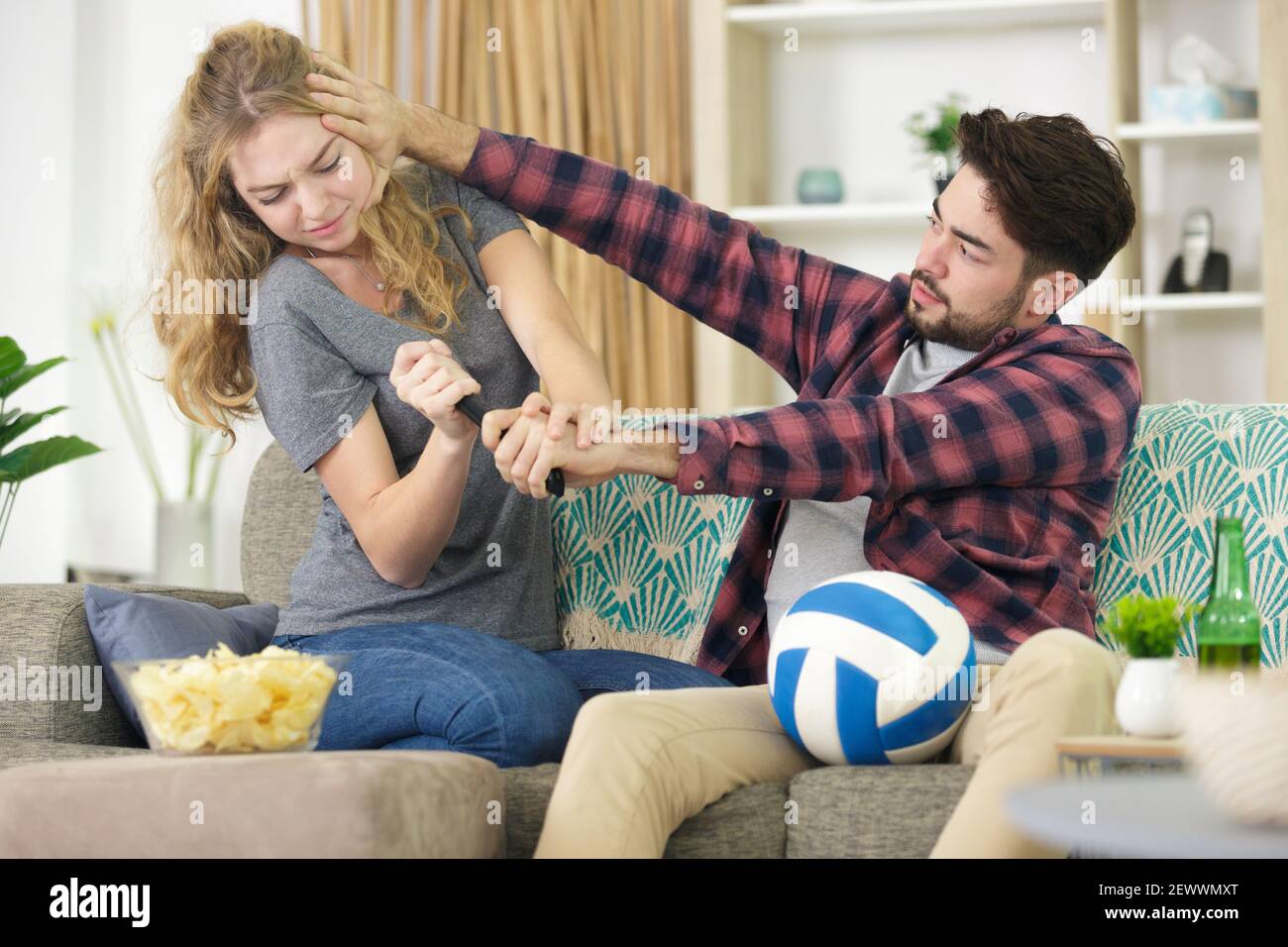 Fighting over the remote control hi-res stock photography and images ...