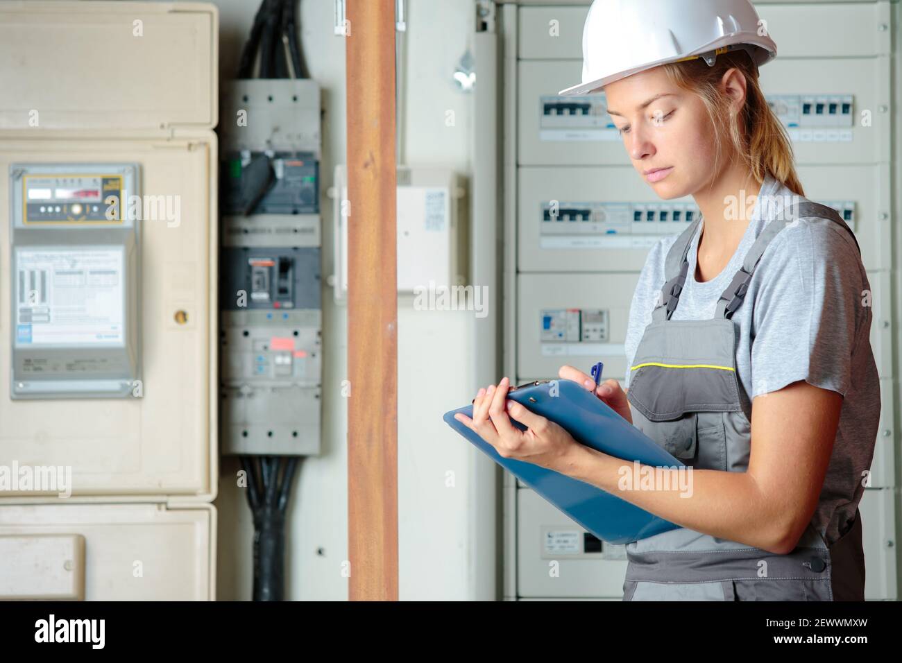 beautiful woman engineer with clipboard taking notes Stock Photo - Alamy