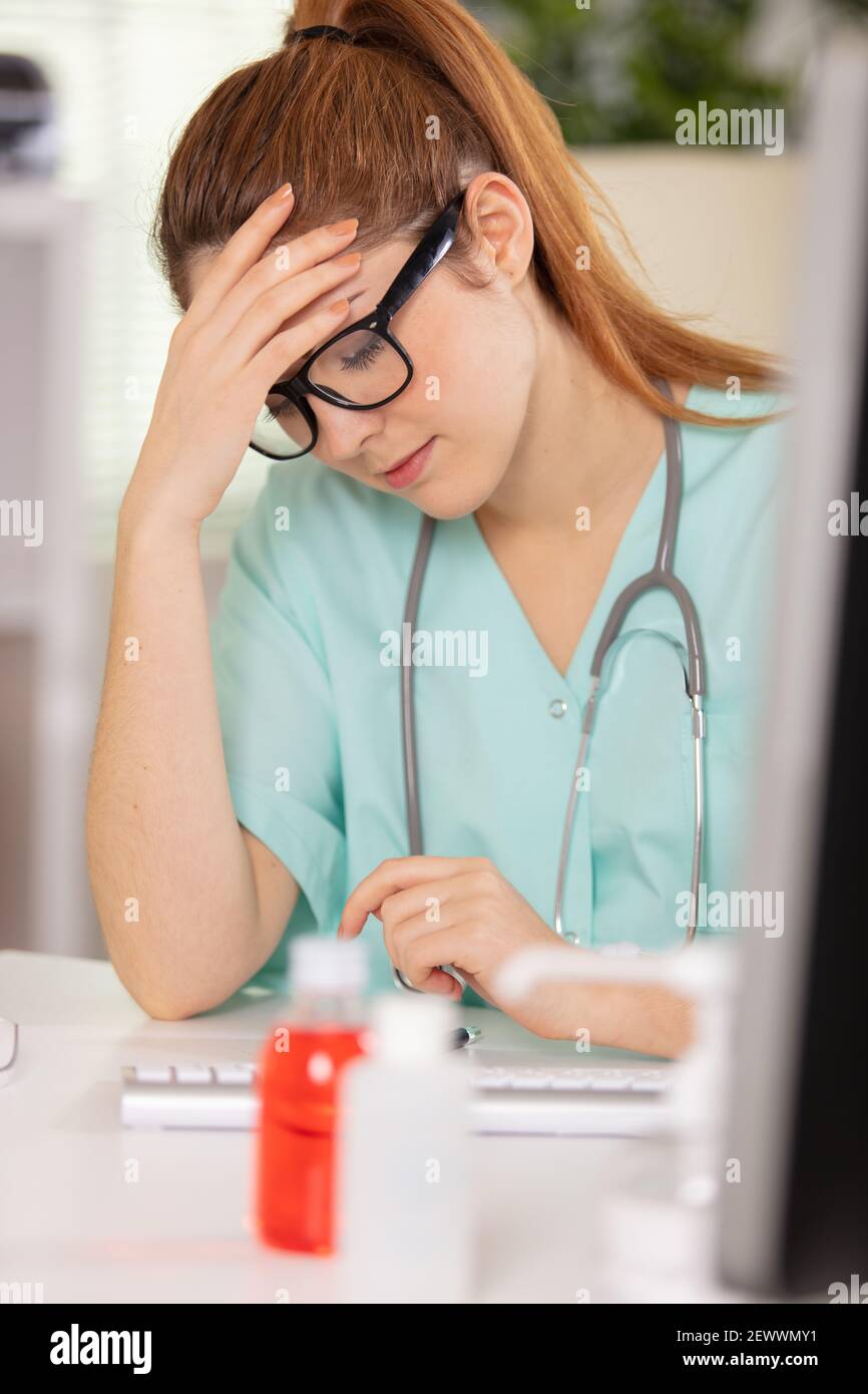 doctor with headache in doctors office Stock Photo - Alamy