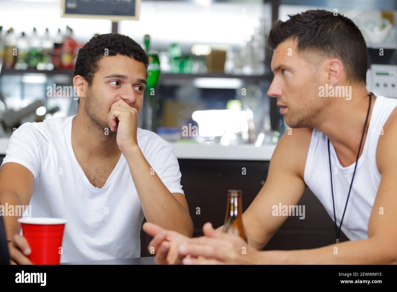 two men sit at a gym bar Stock Photo - Alamy