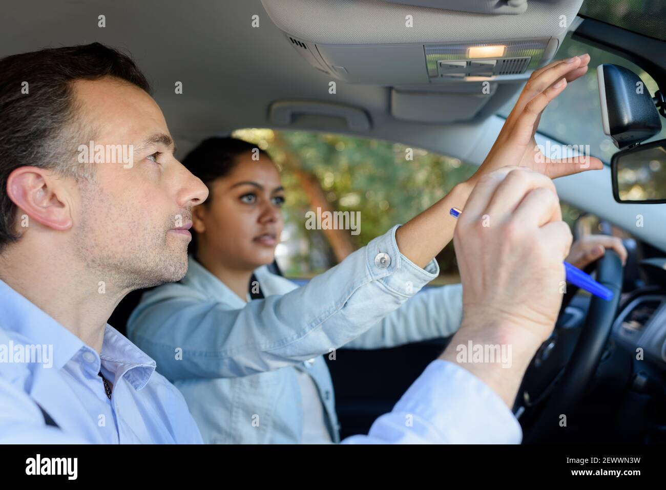 teenager in car with driving instructor Stock Photo - Alamy