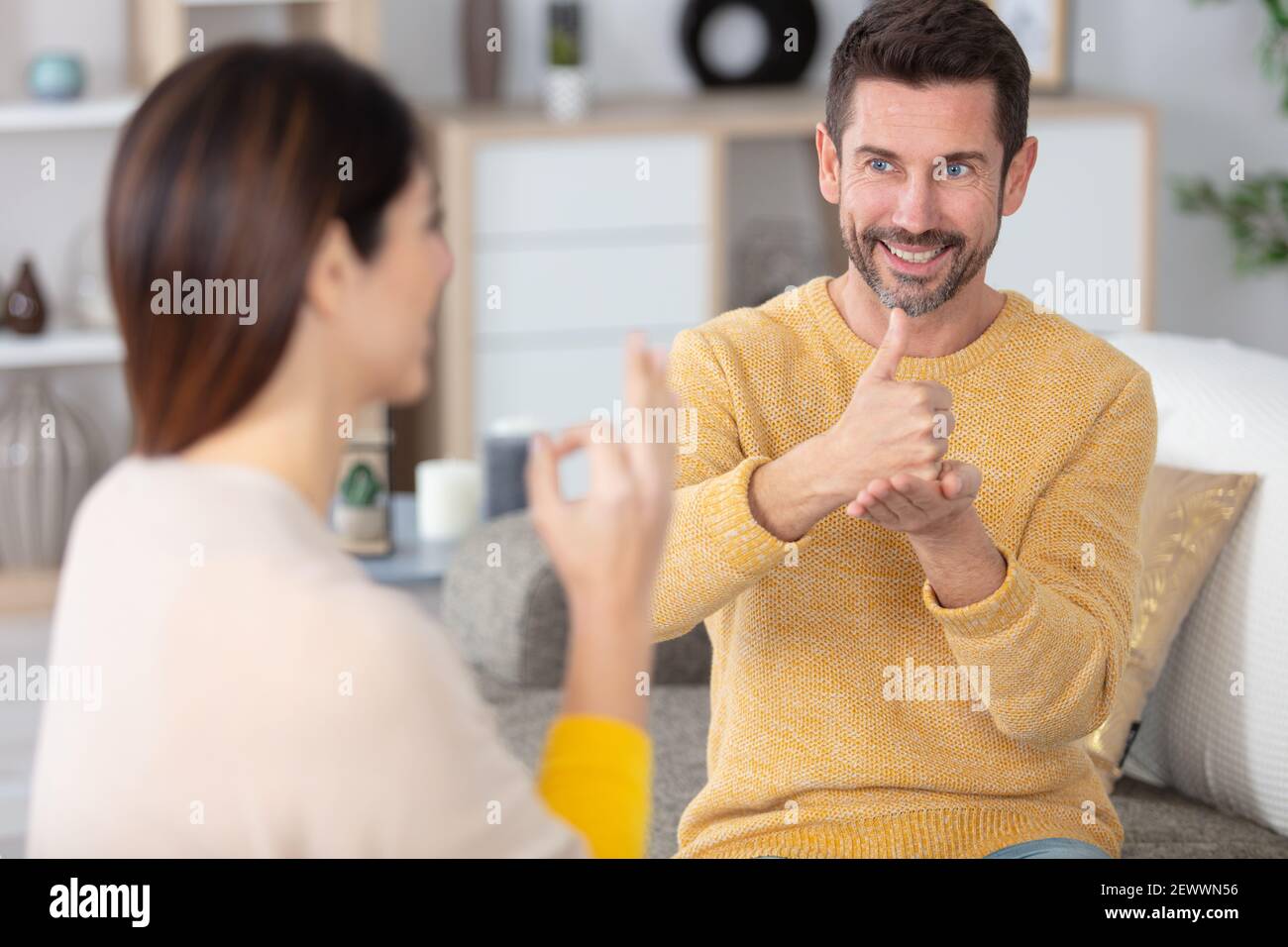 young people discussing using sign language Stock Photo - Alamy