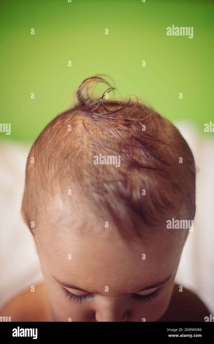 Focus on baby's curl on top of his head Stock Photo - Alamy