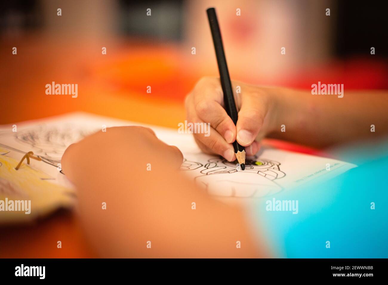 Child's hand holding a black pen - coloring Stock Photo - Alamy