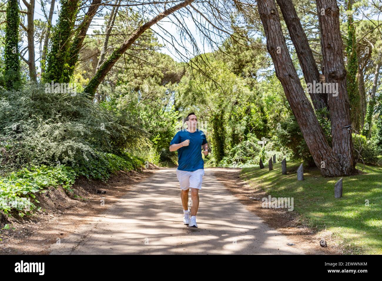 Front View of a man running outdoors training for Marathon Stock Photo ...