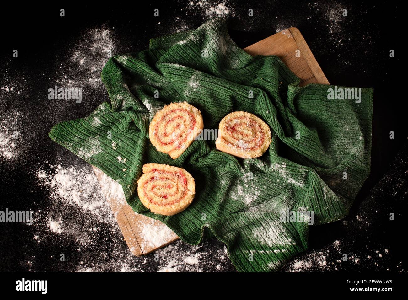 A top view of an appetizing homemade biscuit roll slices on fabric ...