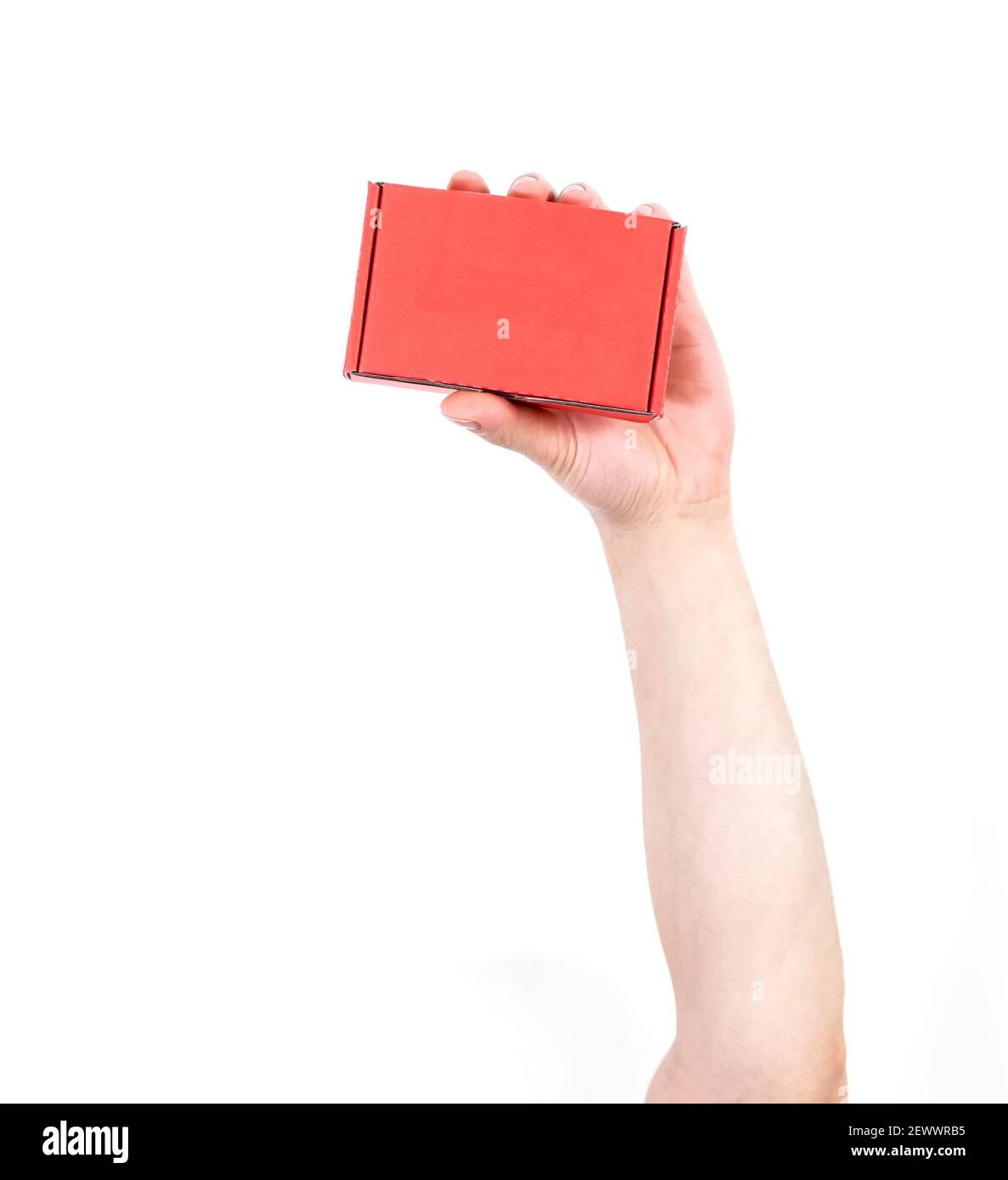 A man's arm raised holding a red cardboard box isolated on white ...