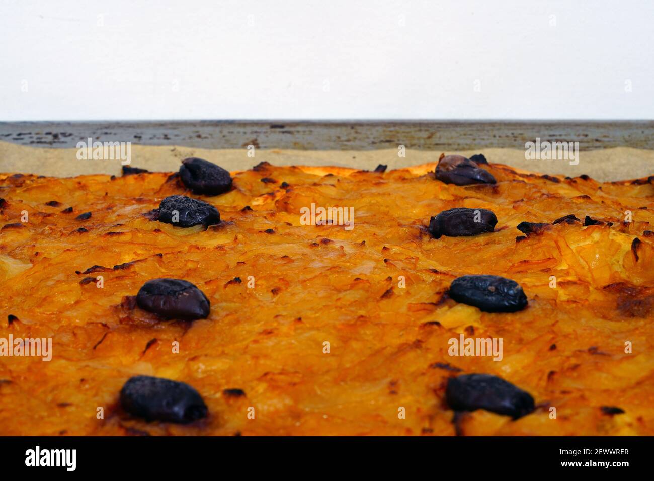 A French pissaladiere tart with onions and black olives Stock Photo - Alamy