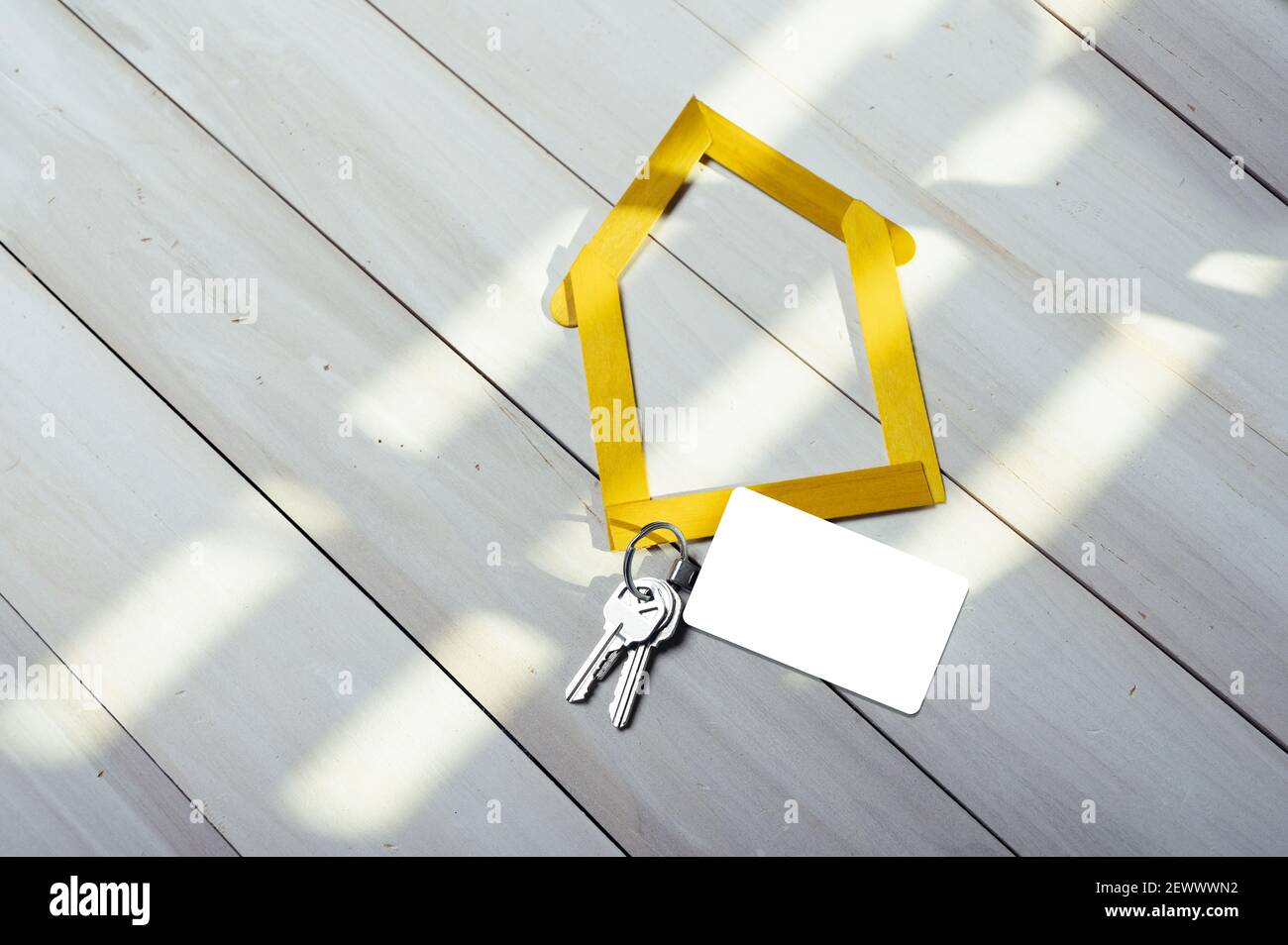 Yellow wood House with keys on white background. Mock up, Real estate ...