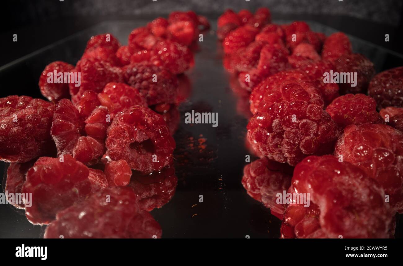 Frozen raspberries in close-up shot Stock Photo - Alamy