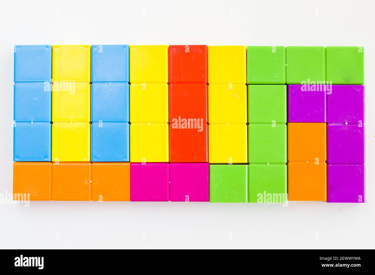a wall with colorful puzzle cubes stacked on each other - geometric ...