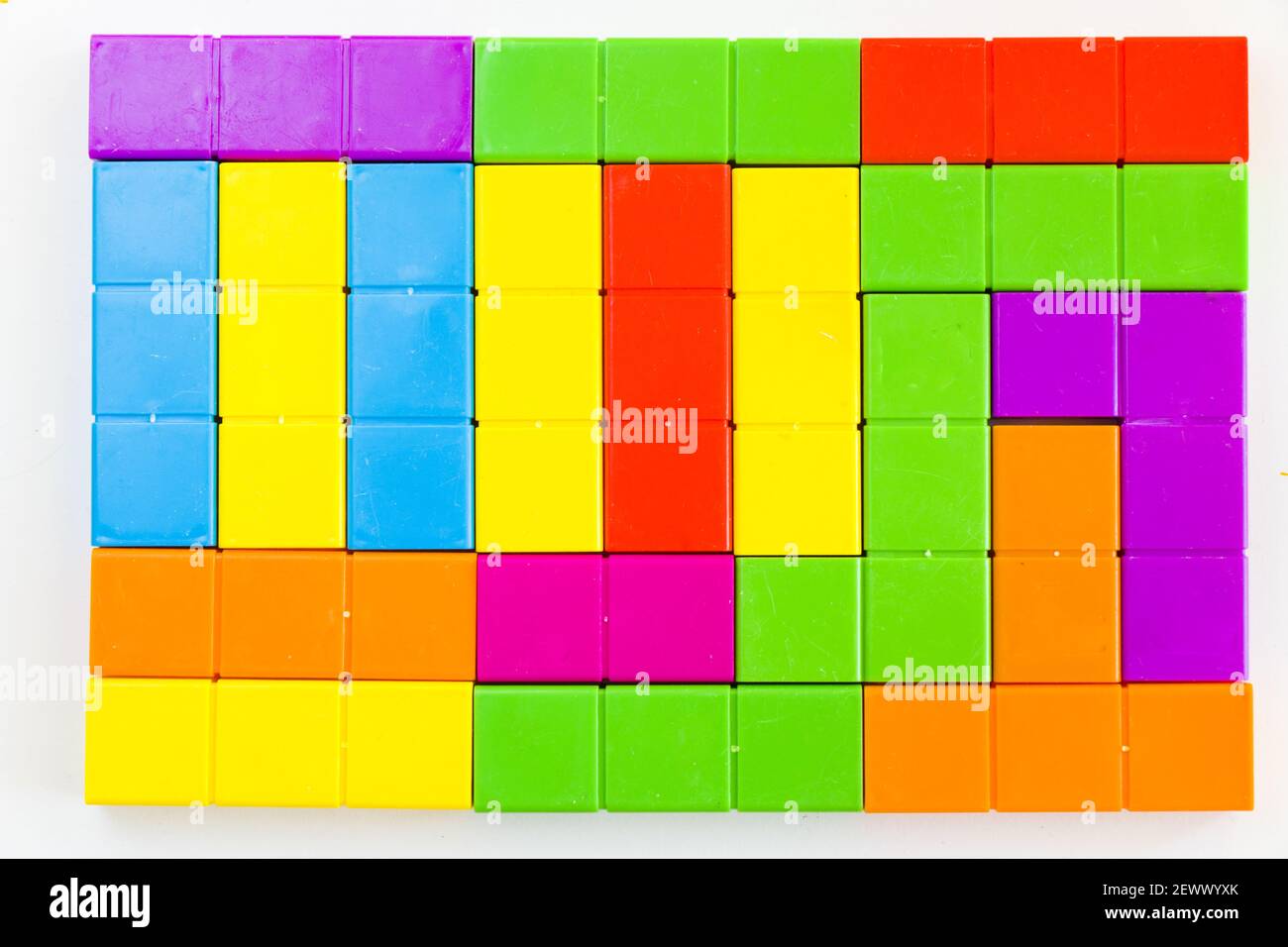 a wall with colorful puzzle cubes stacked on each other - geometric ...