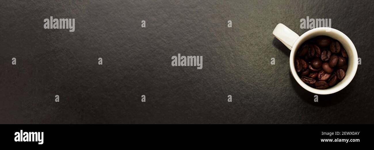 Header template with a burnt coffee grain in the white espresso mug ...