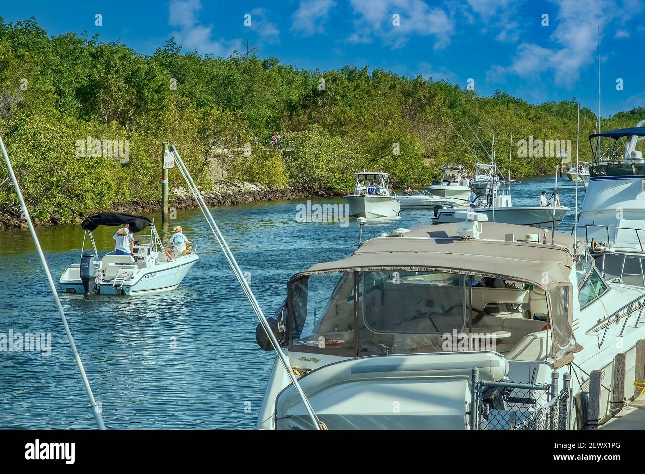 Weekend boats crowd the channel leading into Biscayne Bay at the Black ...