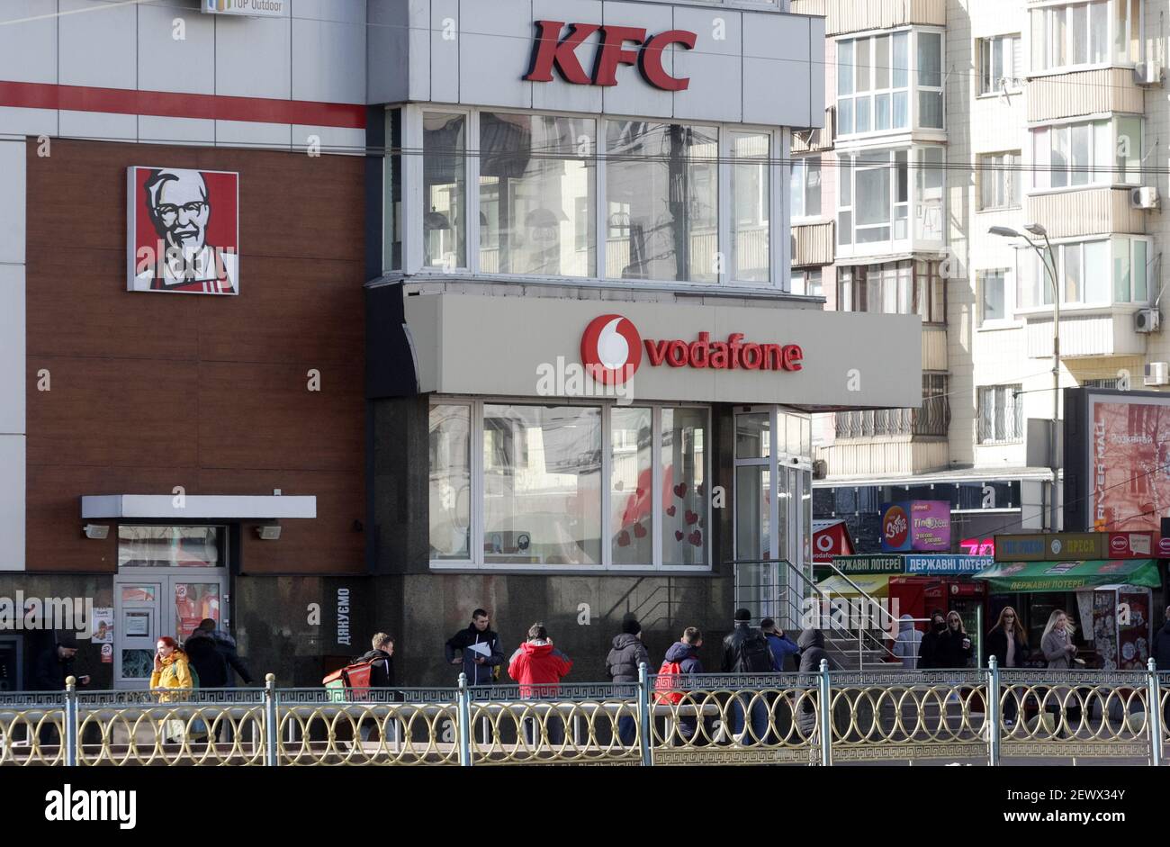 Vodafone and KFC (Kentucky Fried Chicken) logos are seen on a building ...