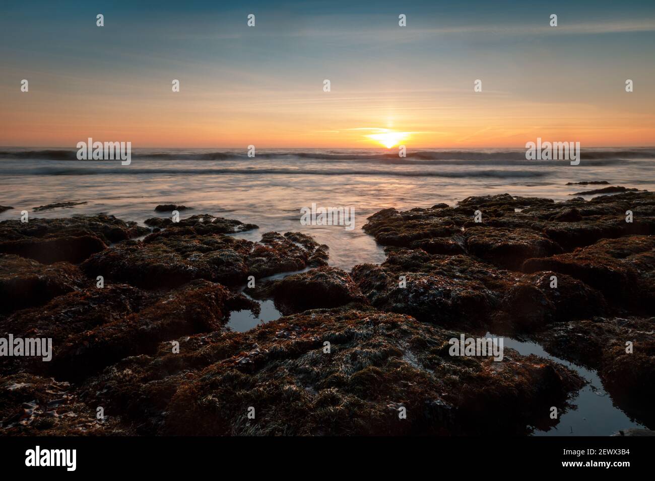 Sun setting over tide pools in the Pacific Ocean Stock Photo - Alamy