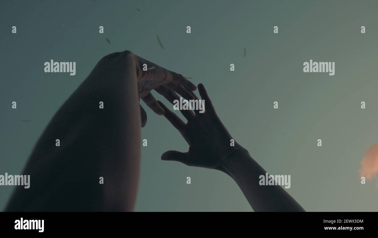 A low angle shot of hands playing in the air under a clear sky Stock ...