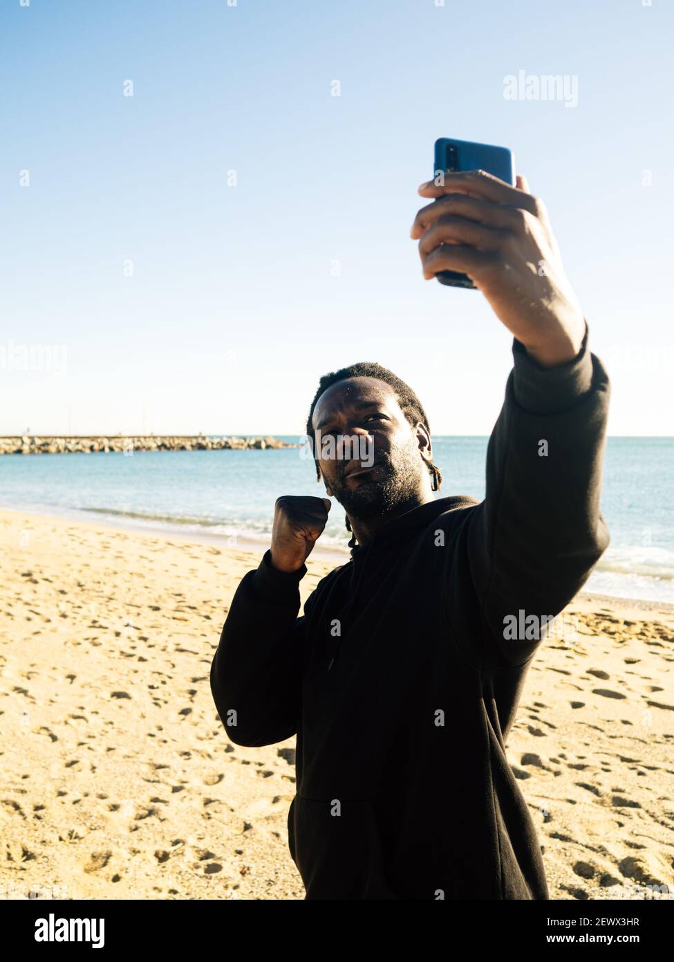 A vertical shot of young African-American male taking a selfie on a ...