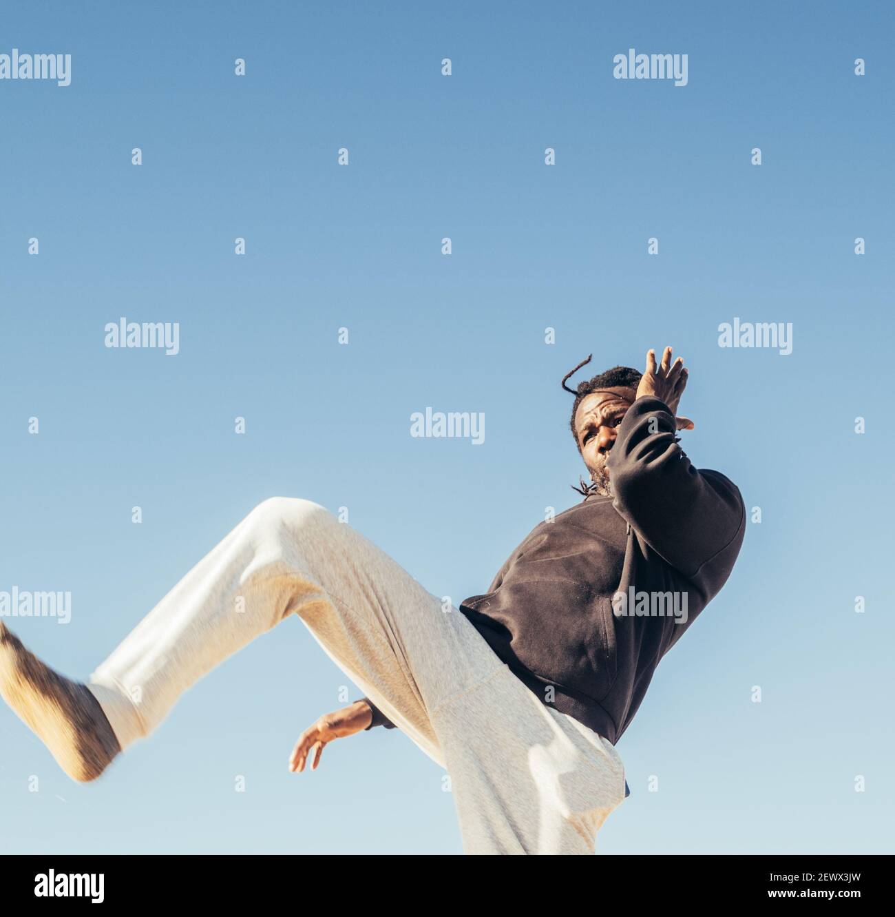 A young African-American male practicing kicking on a beach Stock Photo ...