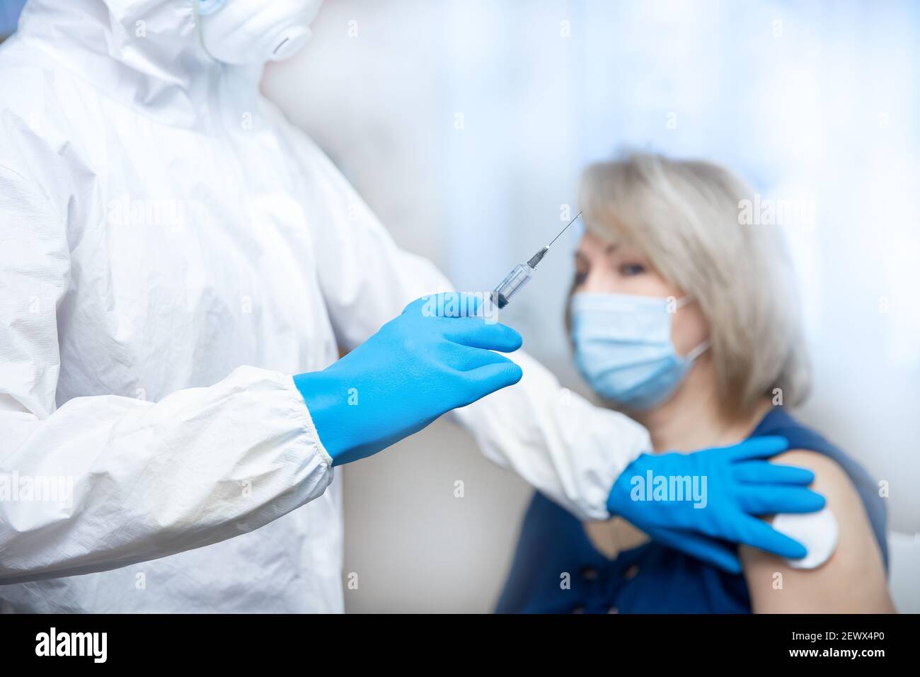 Nurse giving intramuscular injection in hi-res stock photography and ...
