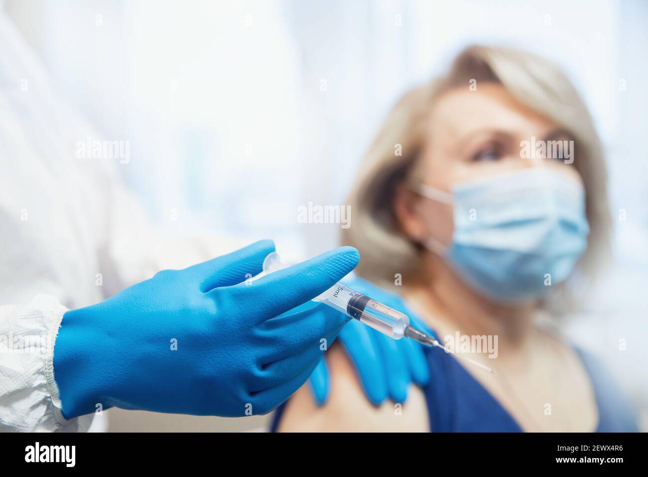 Nurse giving intramuscular injection in hi-res stock photography and ...