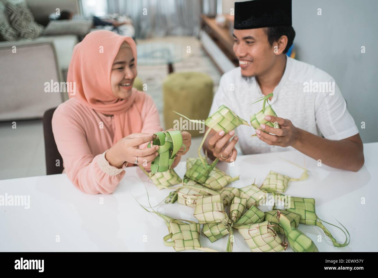 beautiful muslim couple asian making ketupat rice cake at home using ...