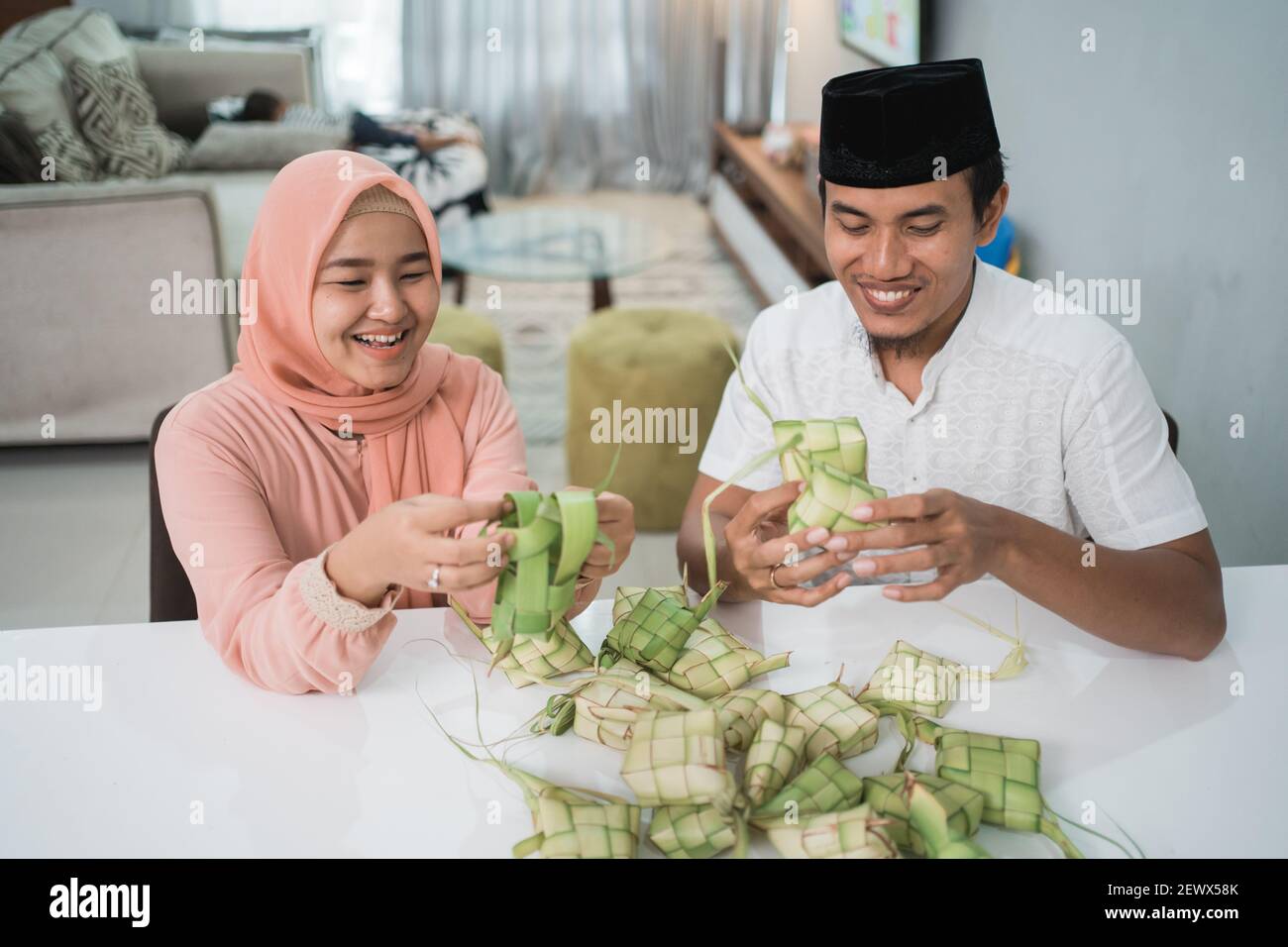 beautiful muslim couple asian making ketupat rice cake at home using ...