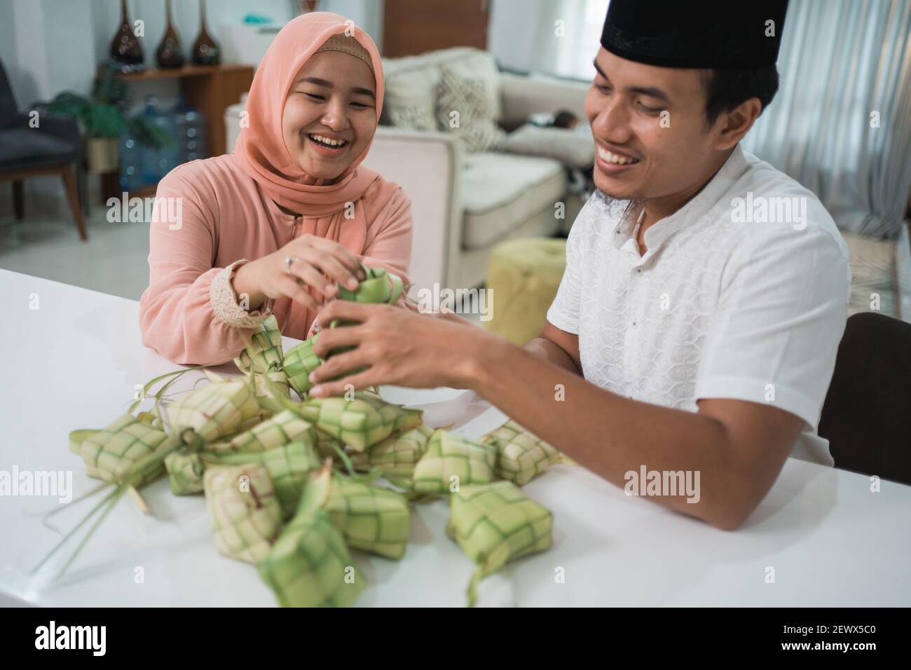 beautiful muslim couple asian making ketupat rice cake at home using ...