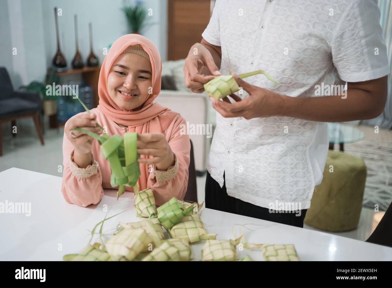 beautiful muslim couple asian making ketupat rice cake at home using ...