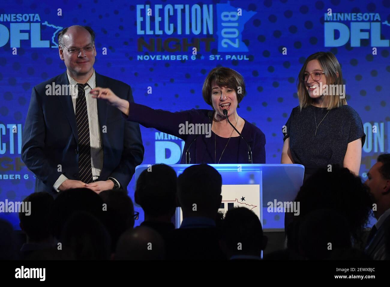 Sen. Amy Klobuchar is flanked by her husband, John Bessler, and her ...