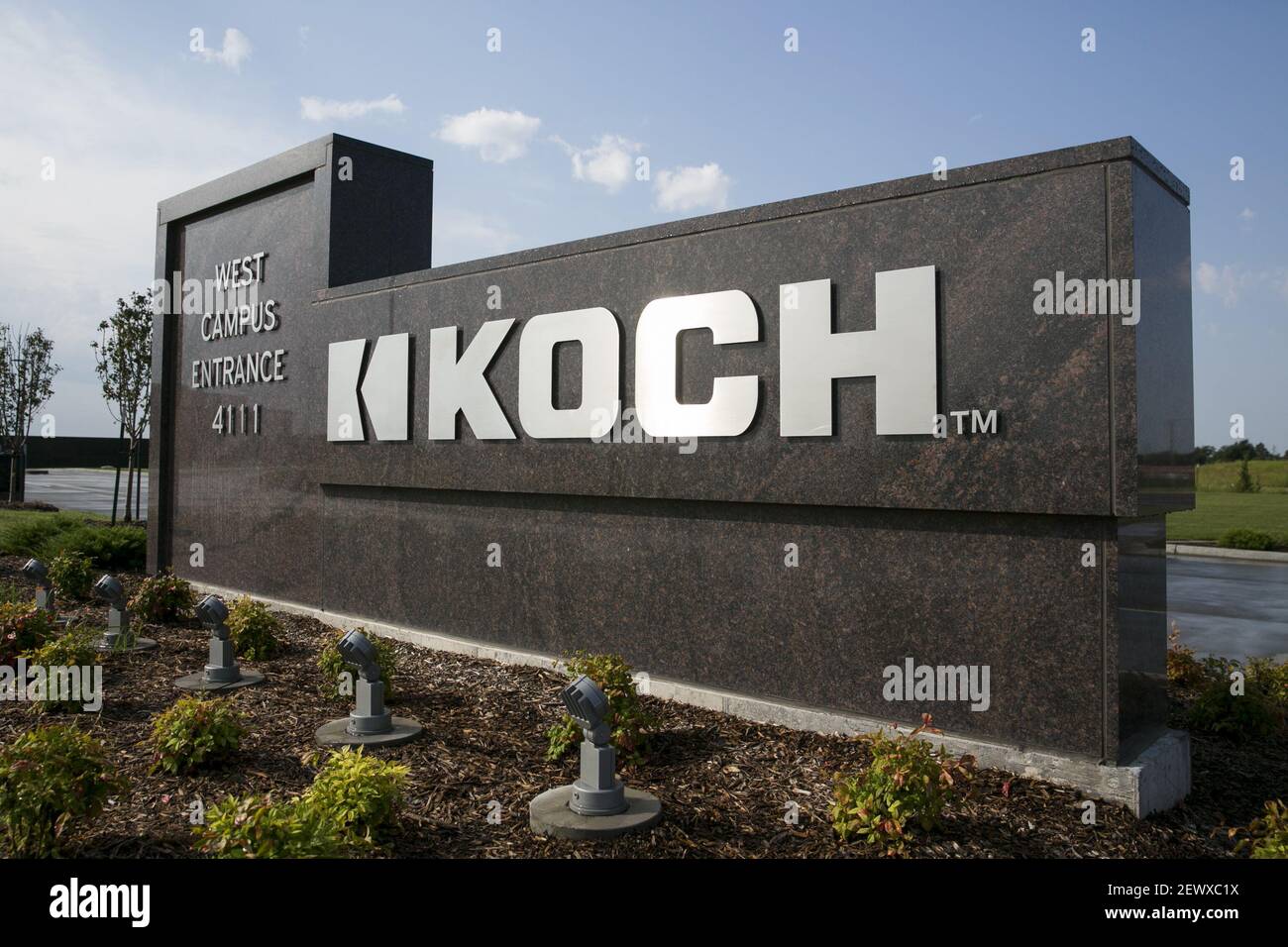 A logo sign outside of the headquarters of Koch Industries, Inc., in ...