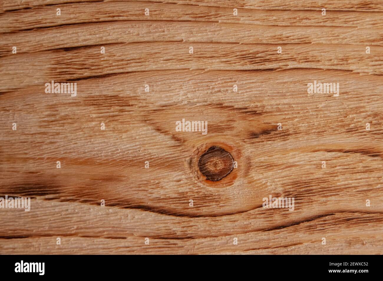 The texture of a pine board with a knot, after firing and machining ...