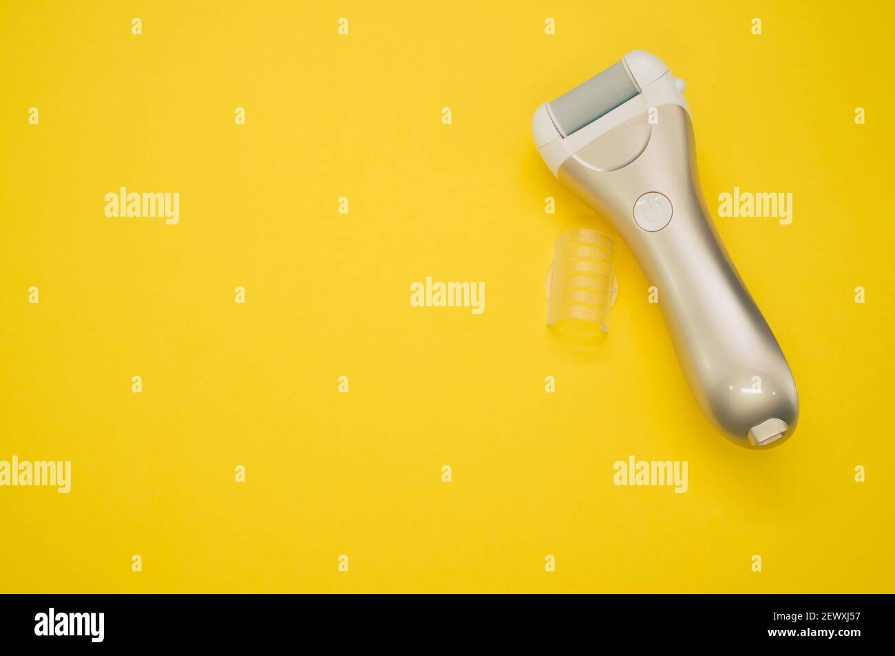 A top view of an electric foot file isolated on a yellow background ...