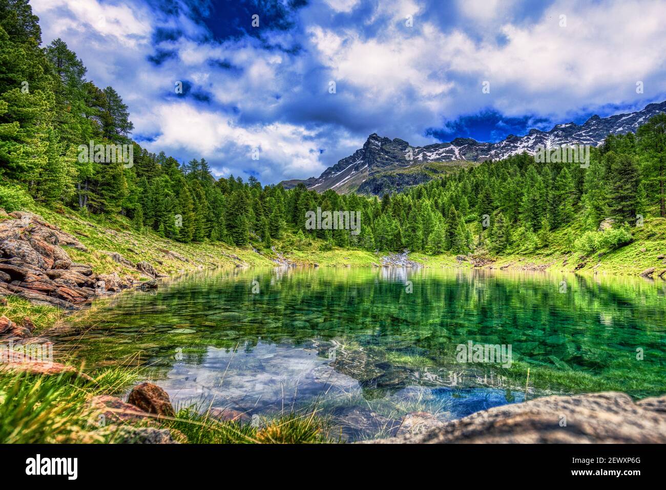 Amazing clear water in Scispadus Lake with the Swiss Alps in the ...