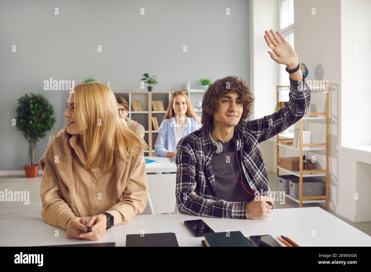 High school girl raising hand hi-res stock photography and images - Alamy