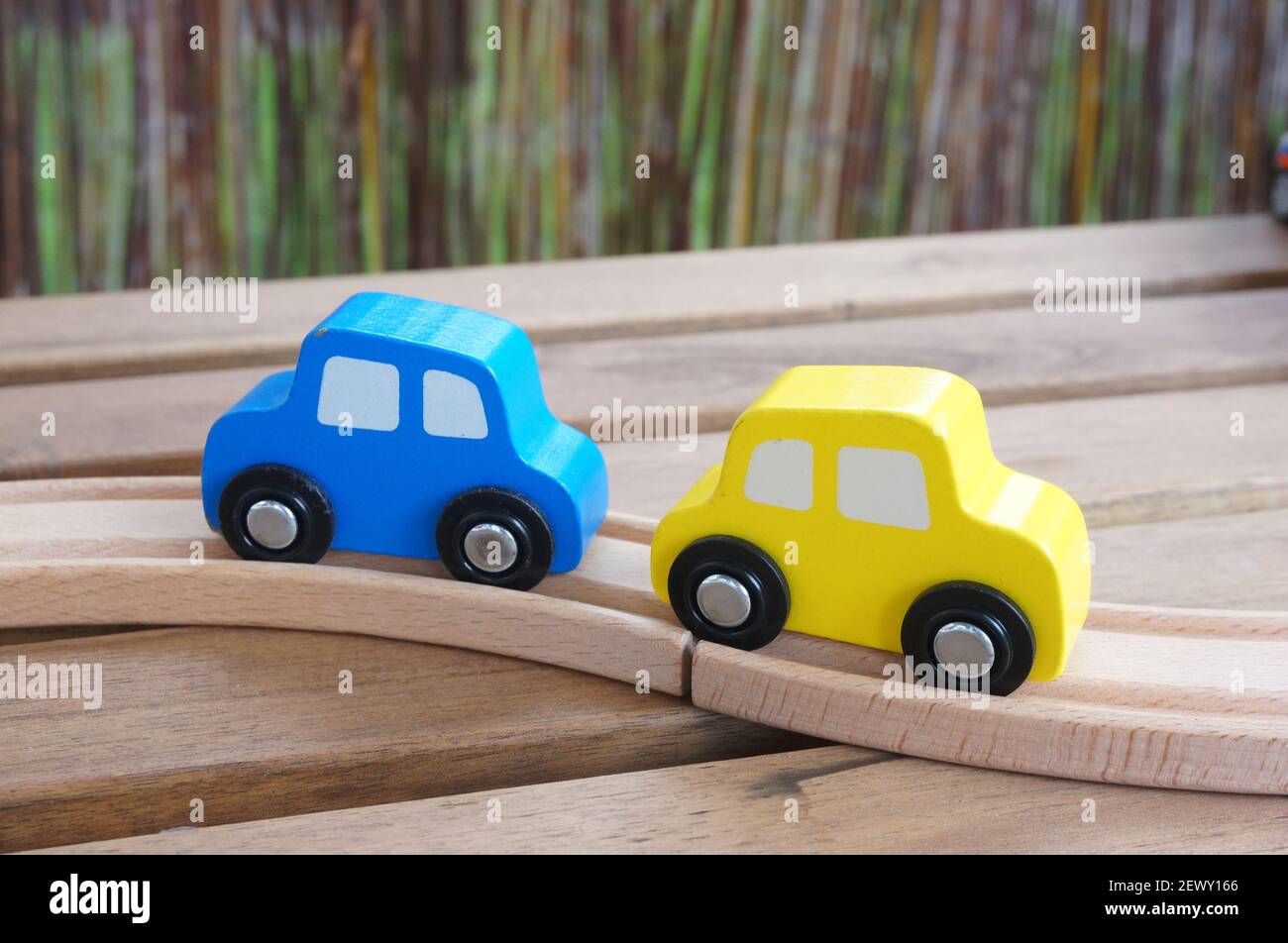 Wooden blue and yellow toy cars on a track Stock Photo - Alamy