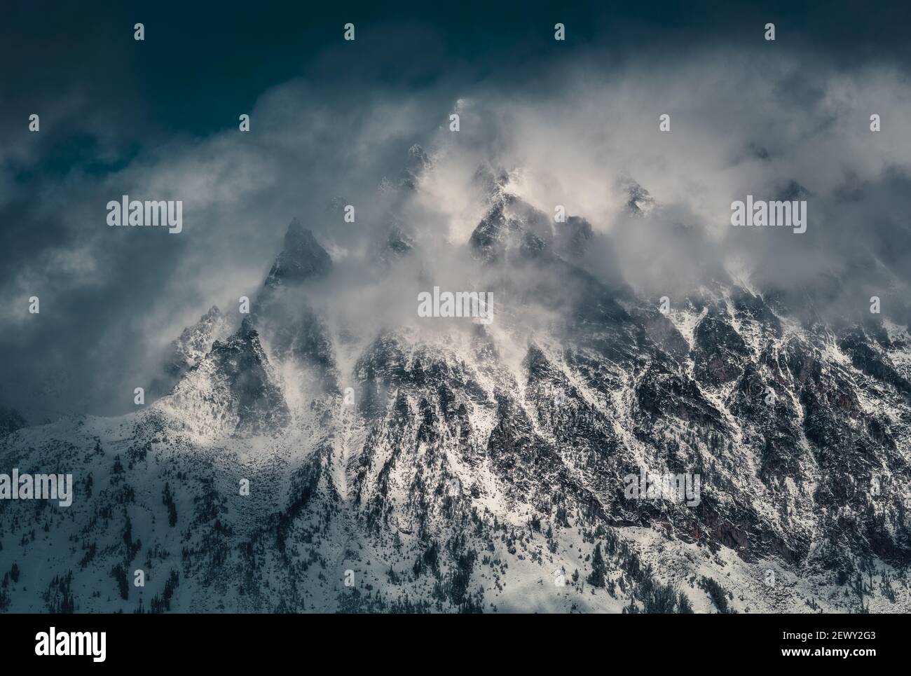Panorama of dramatic snowy peaks above the clouds in the North Cascades ...