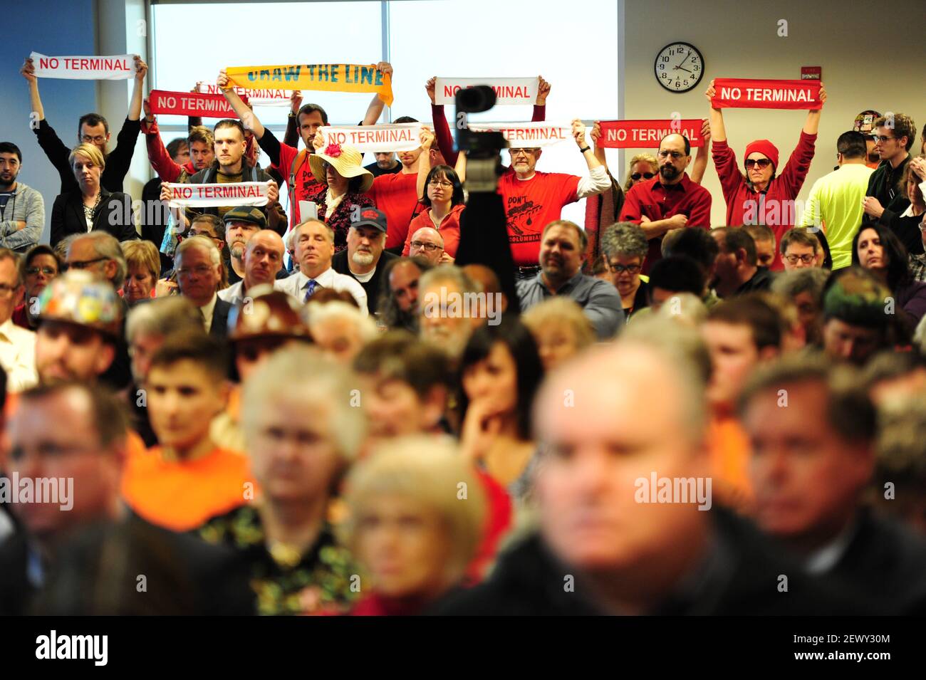 Protesters hold up signs opposing Pembina's proposed propane export ...