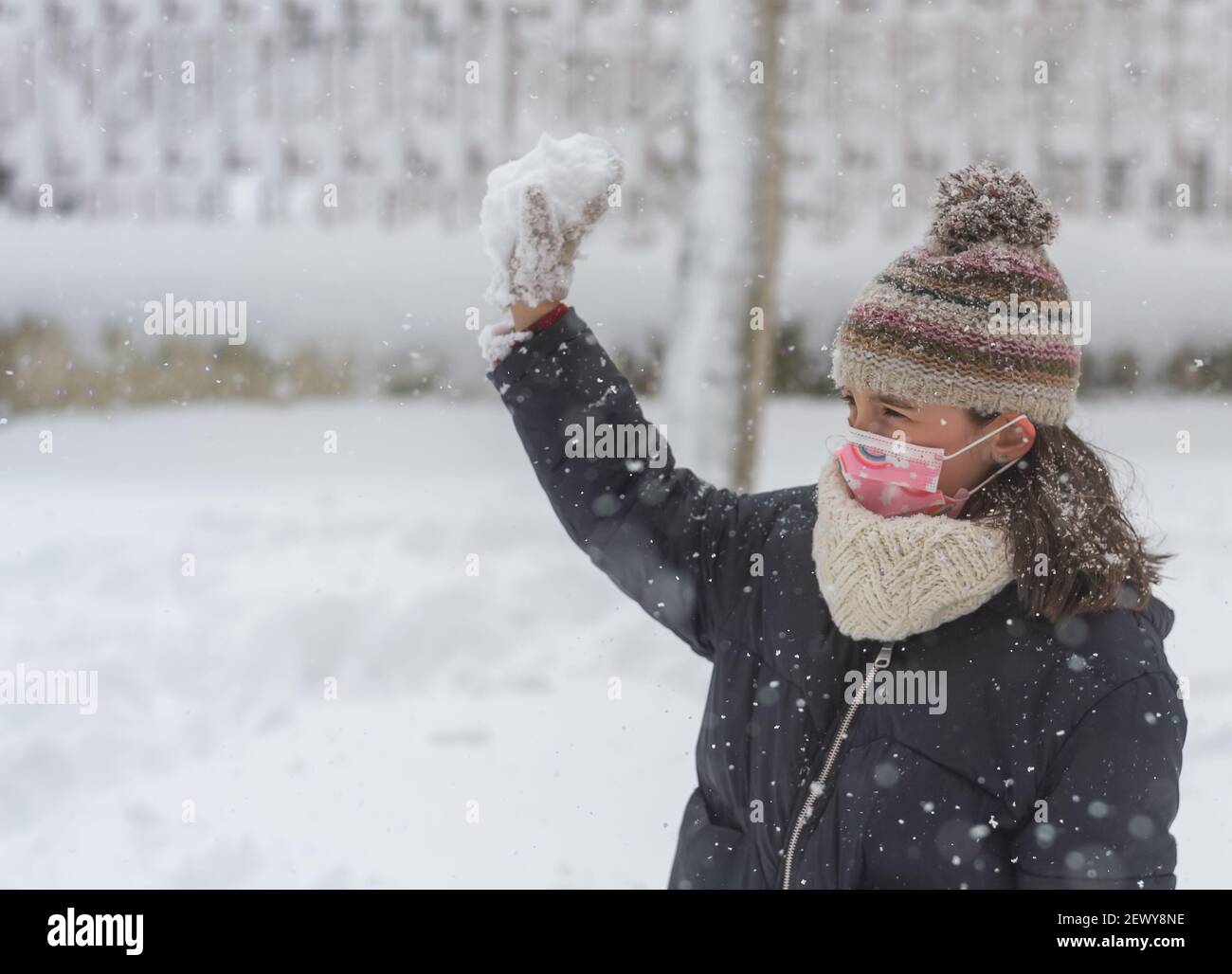 The picture shows a side view of a little girl wearing a coronavirus ...
