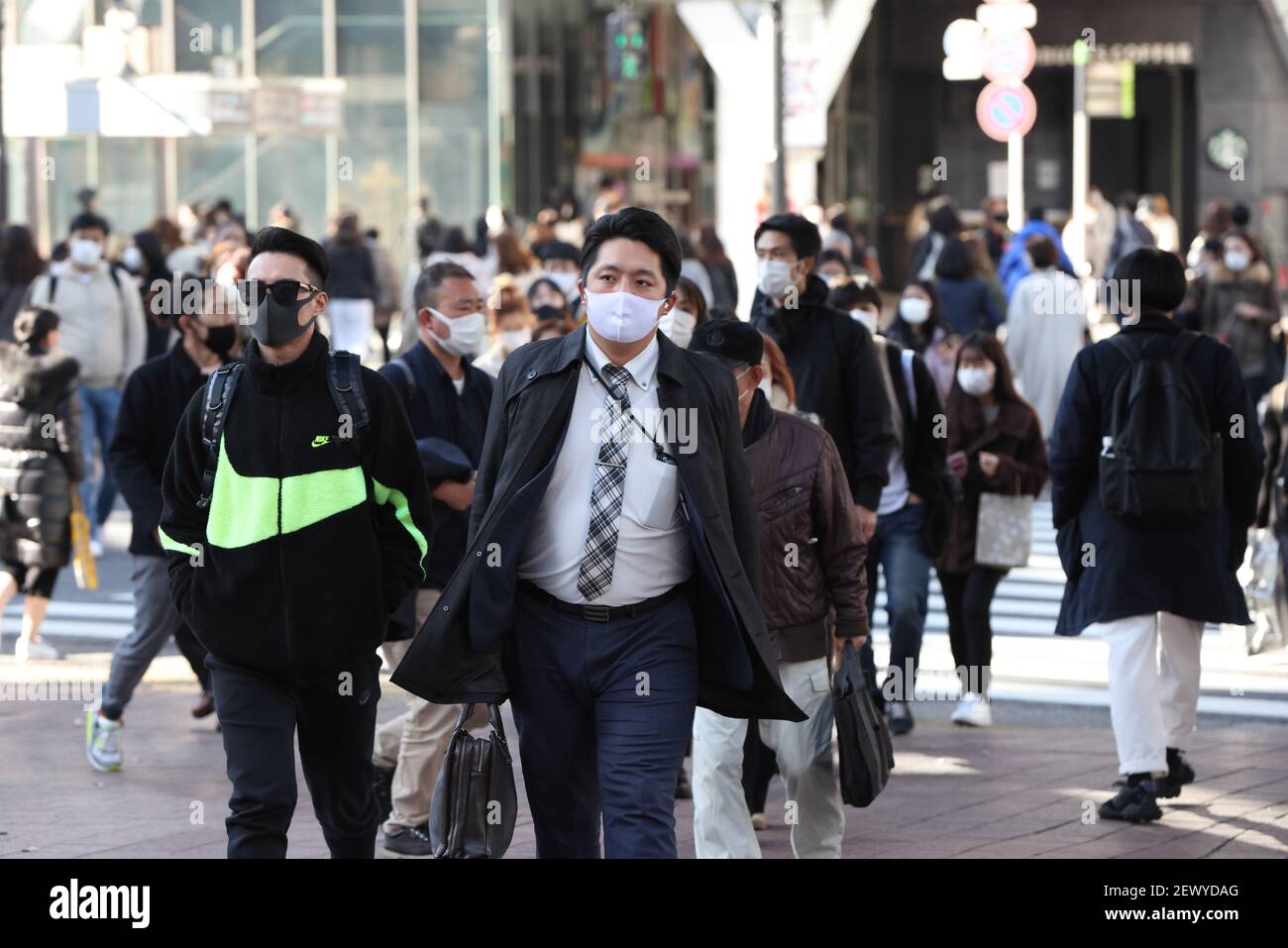 Tokyo, Japan. 03rd Mar, 2021. Pedestrians wearing face masks as a ...