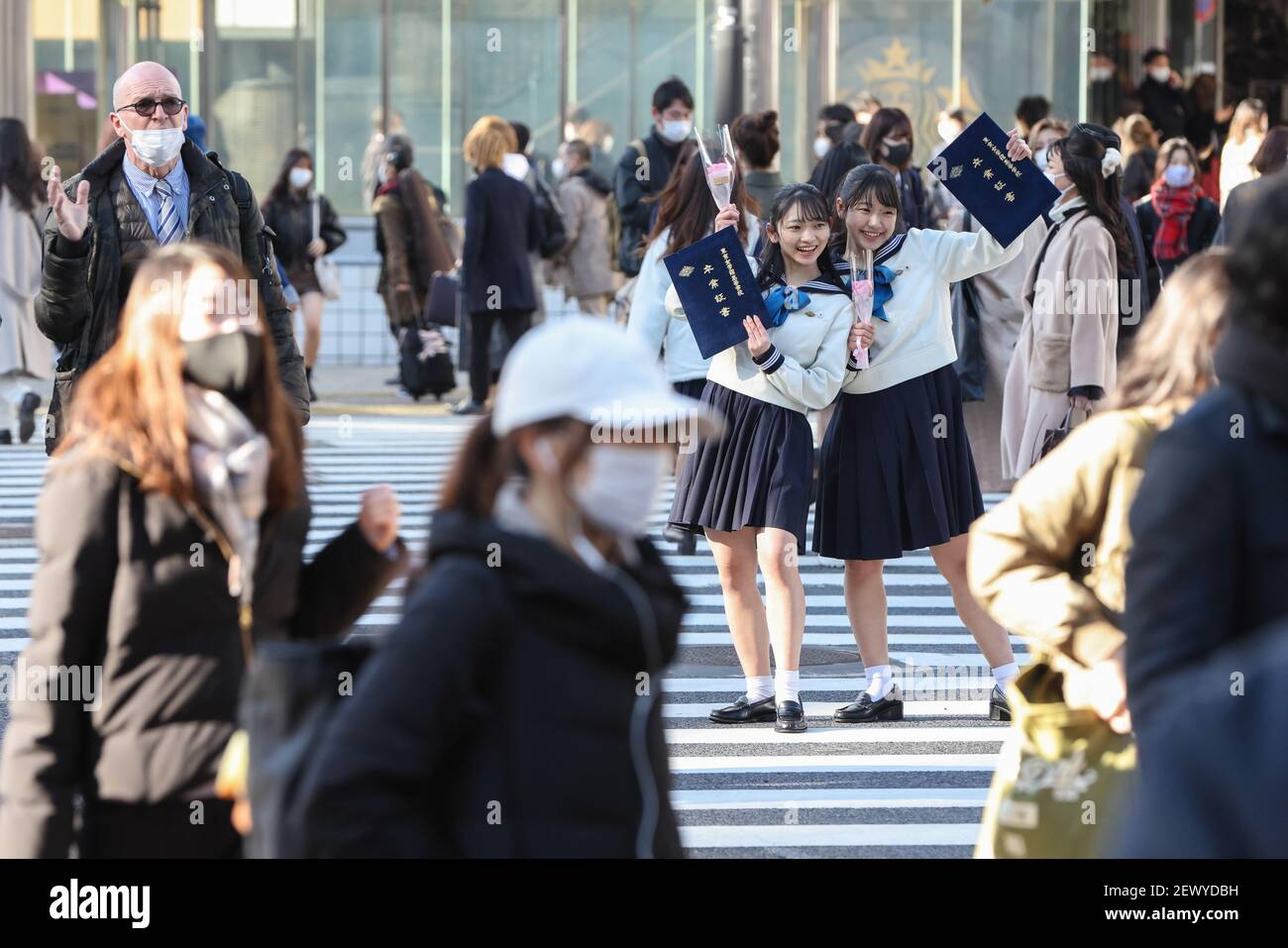 Highschool girls in uniform take photos with their graduation ...