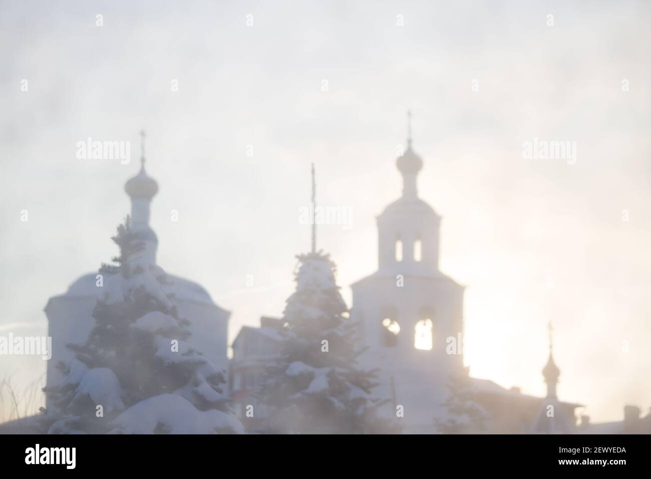 Bllured image of white orthodox church in mist Stock Photo - Alamy