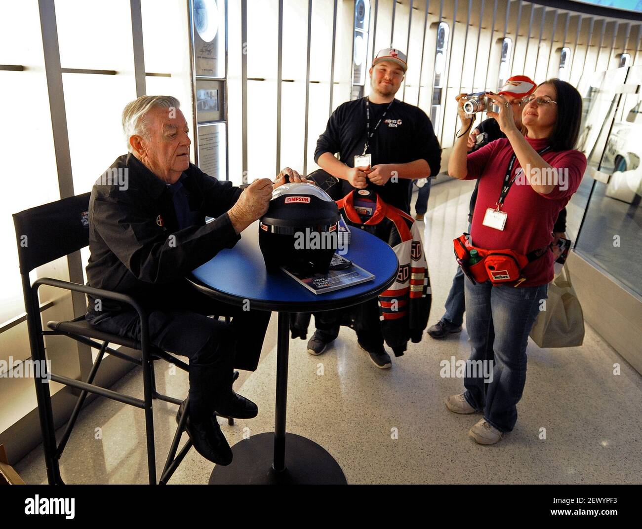 NASCAR Hall of Fame member Bobby Allison, left, signs autographs for ...